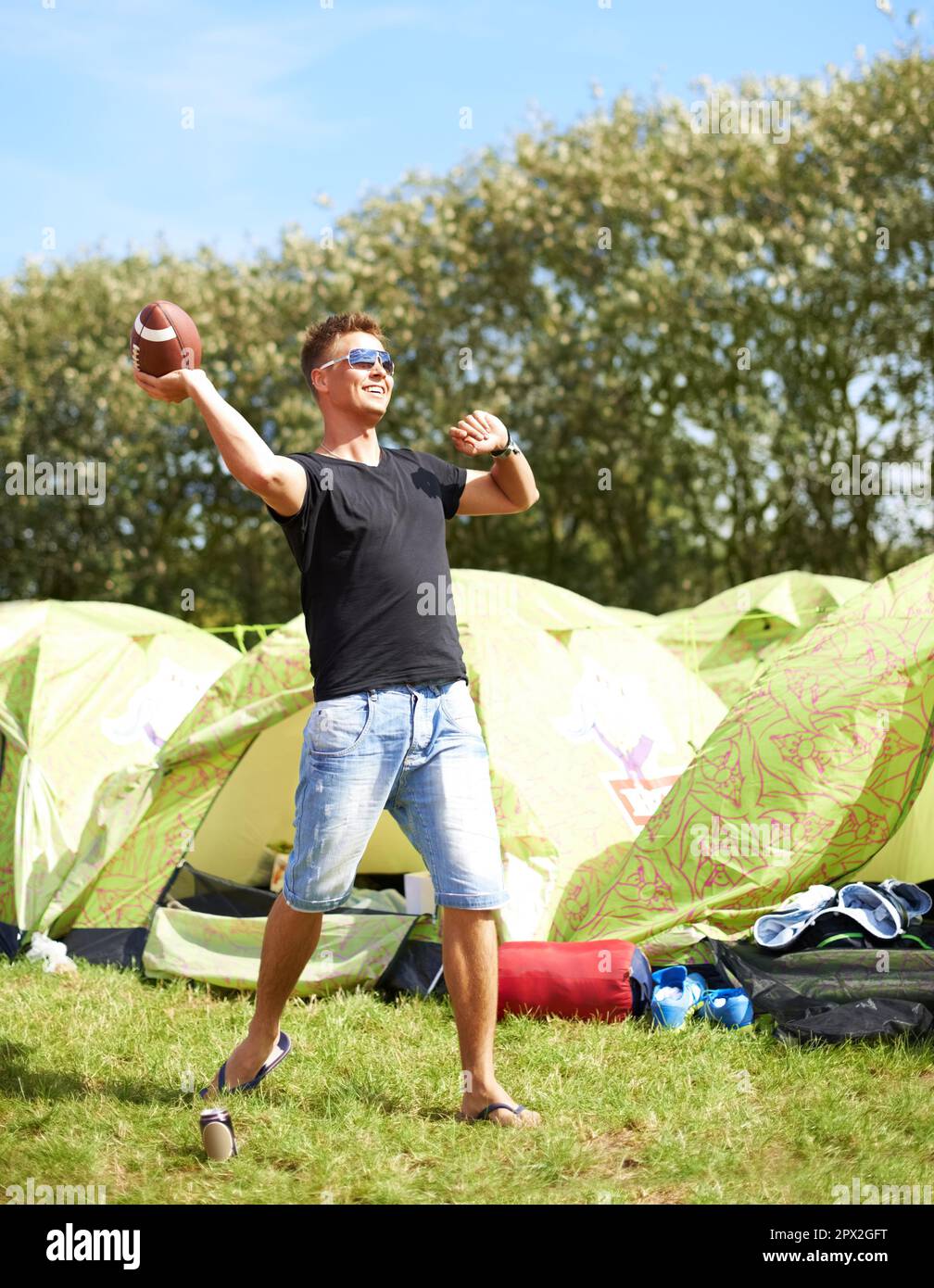 Anyone up for a game of catch. a young man standing outside his tent ...