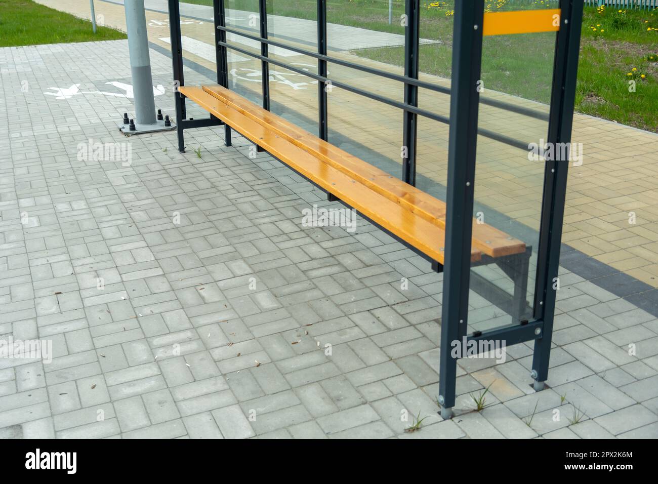 New glass shelter bus stop with wooden bench Stock Photo - Alamy