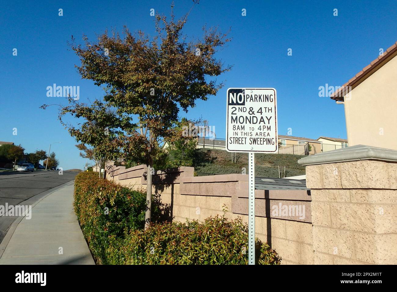 Street sweeping no parking sign in residential neighborhood Stock Photo ...