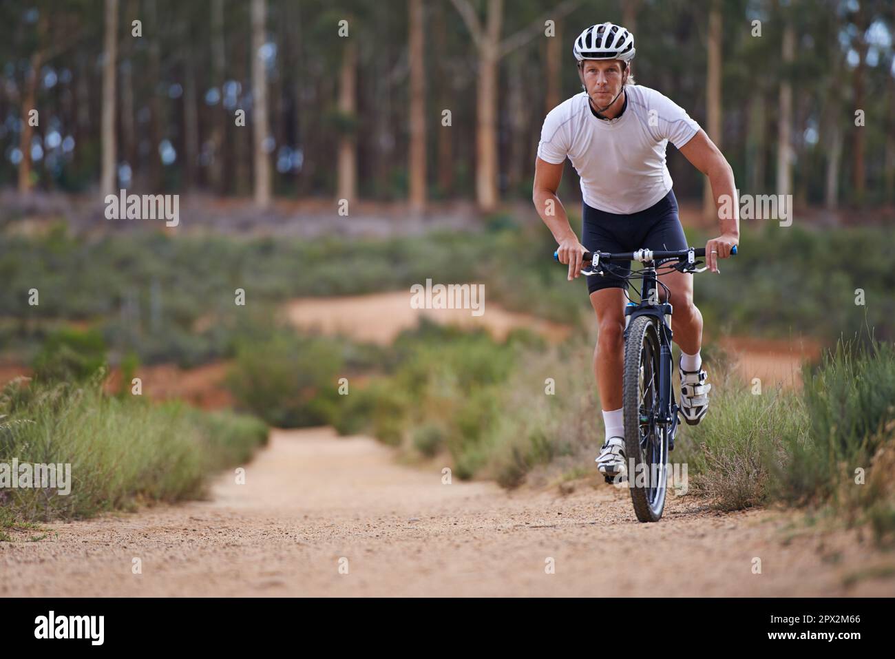 Nothing beats an extreme bike ride. Fit cyclist riding across rough ...