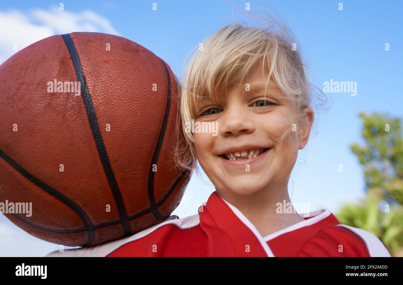 Happy little basketball player. A cute little girl holding a basketball ...