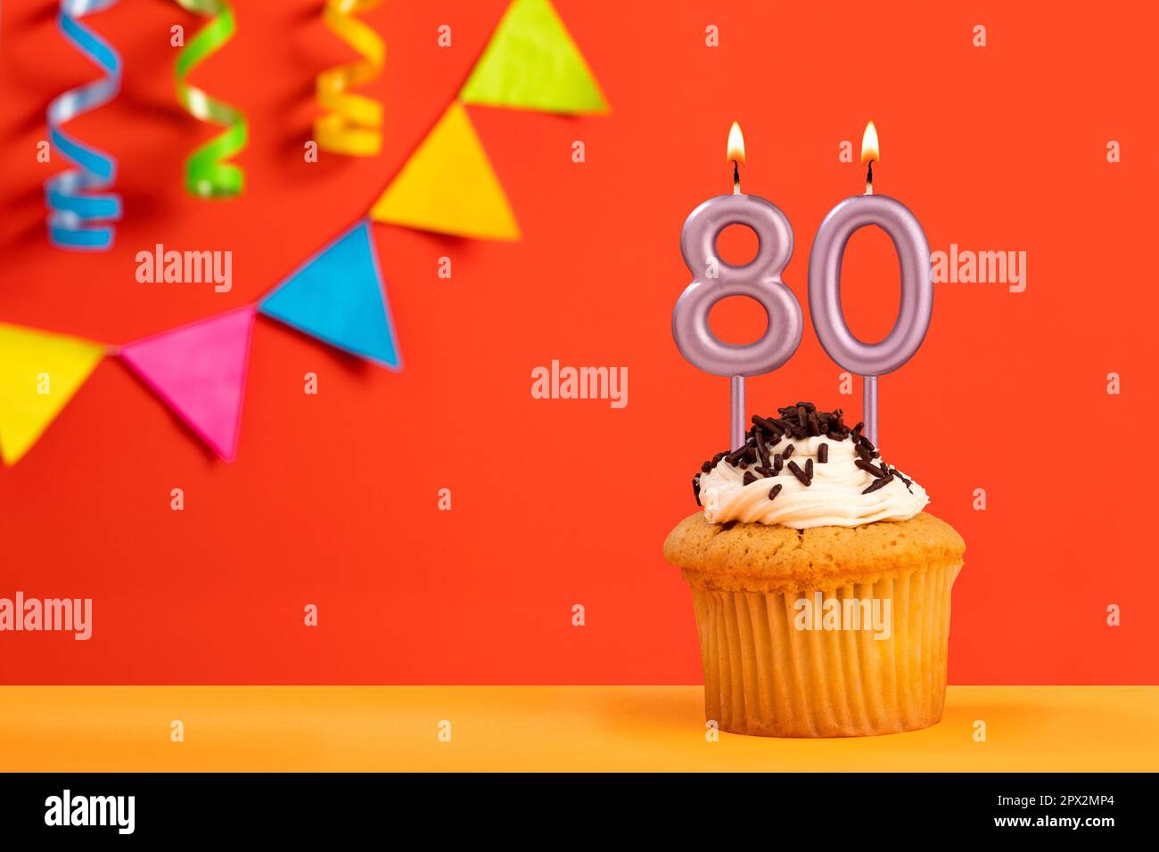 Birthday cake with number 80 candle - Sparkling orange background with ...