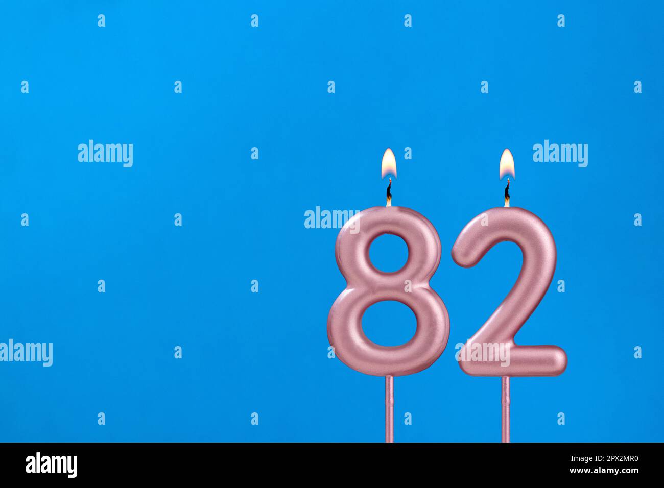Candle number 82 - Birthday in blues foamy background Stock Photo - Alamy