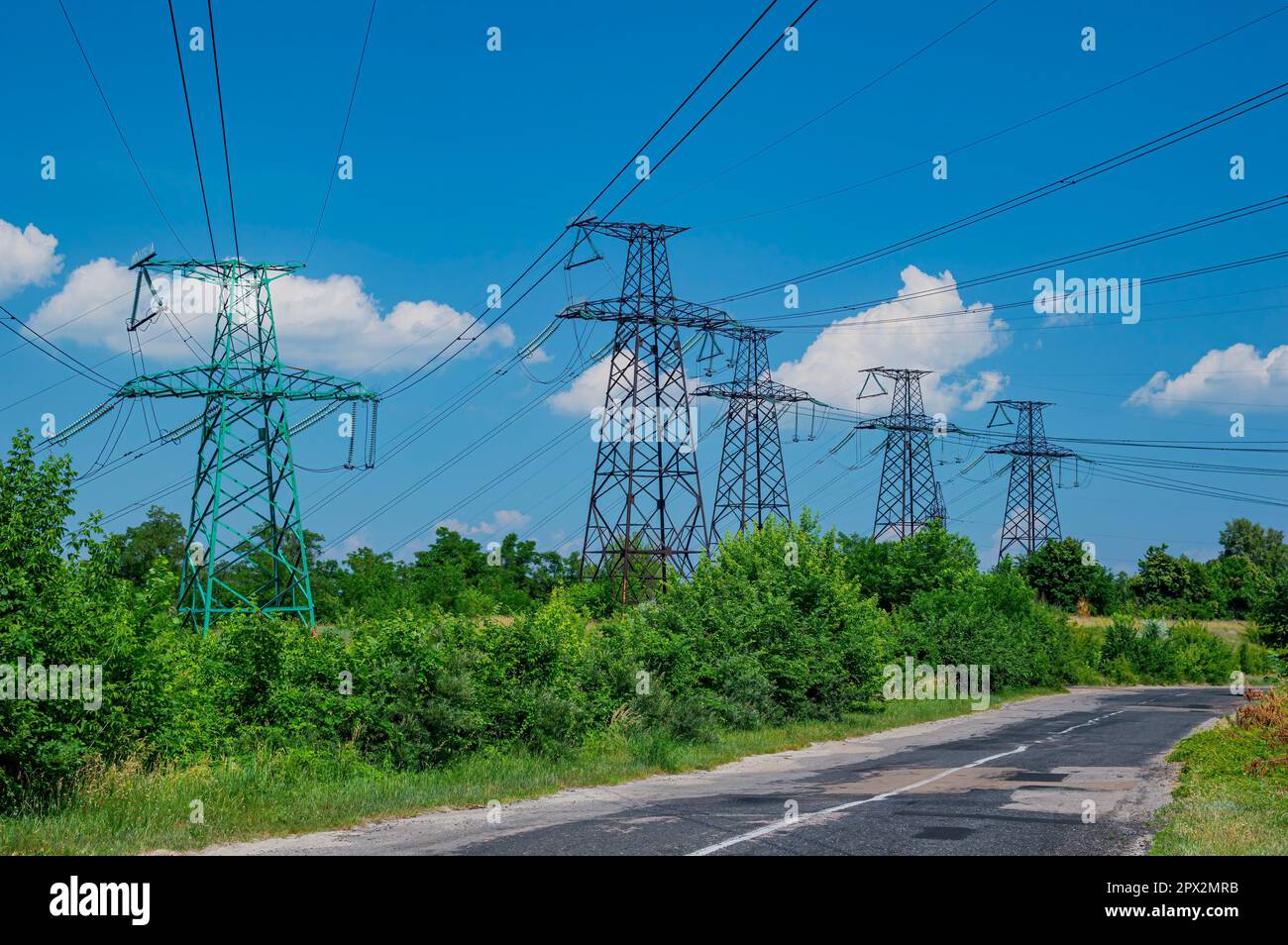 Tower with high-voltage energy transmission wires against the blue sky ...
