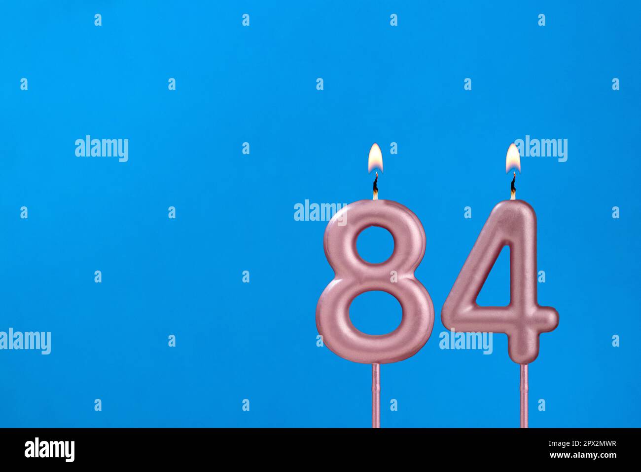 Candle number 84 - Birthday in blues foamy background Stock Photo - Alamy