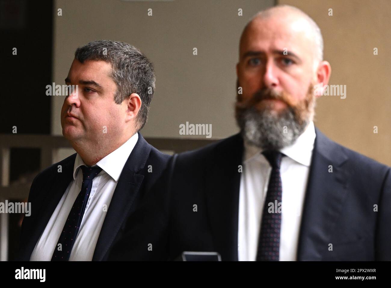 Timothy Whittaker (left) arrives at the Melbourne Magistrates Court in ...