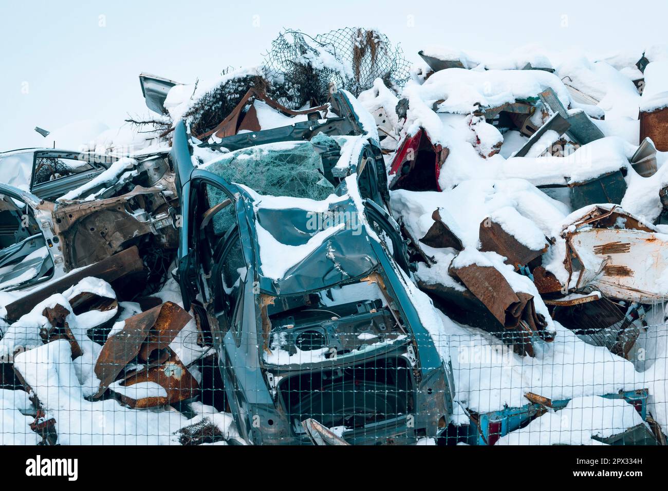 Junkyard with scrap metal and damaged cars in the snow Stock Photo - Alamy