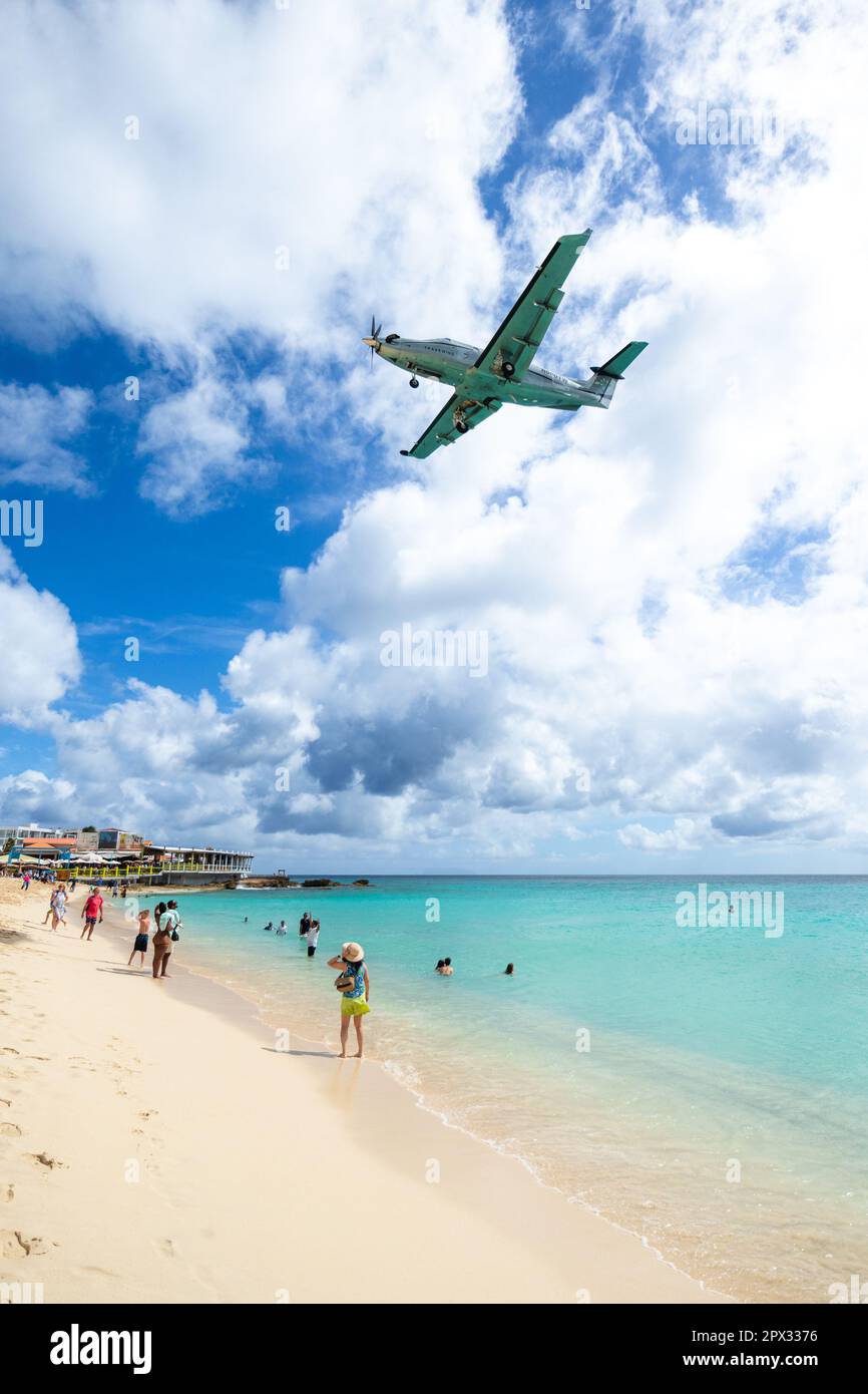 A Tradewind Pilatus PC-12 plane lands over Maho Beach at Princess ...