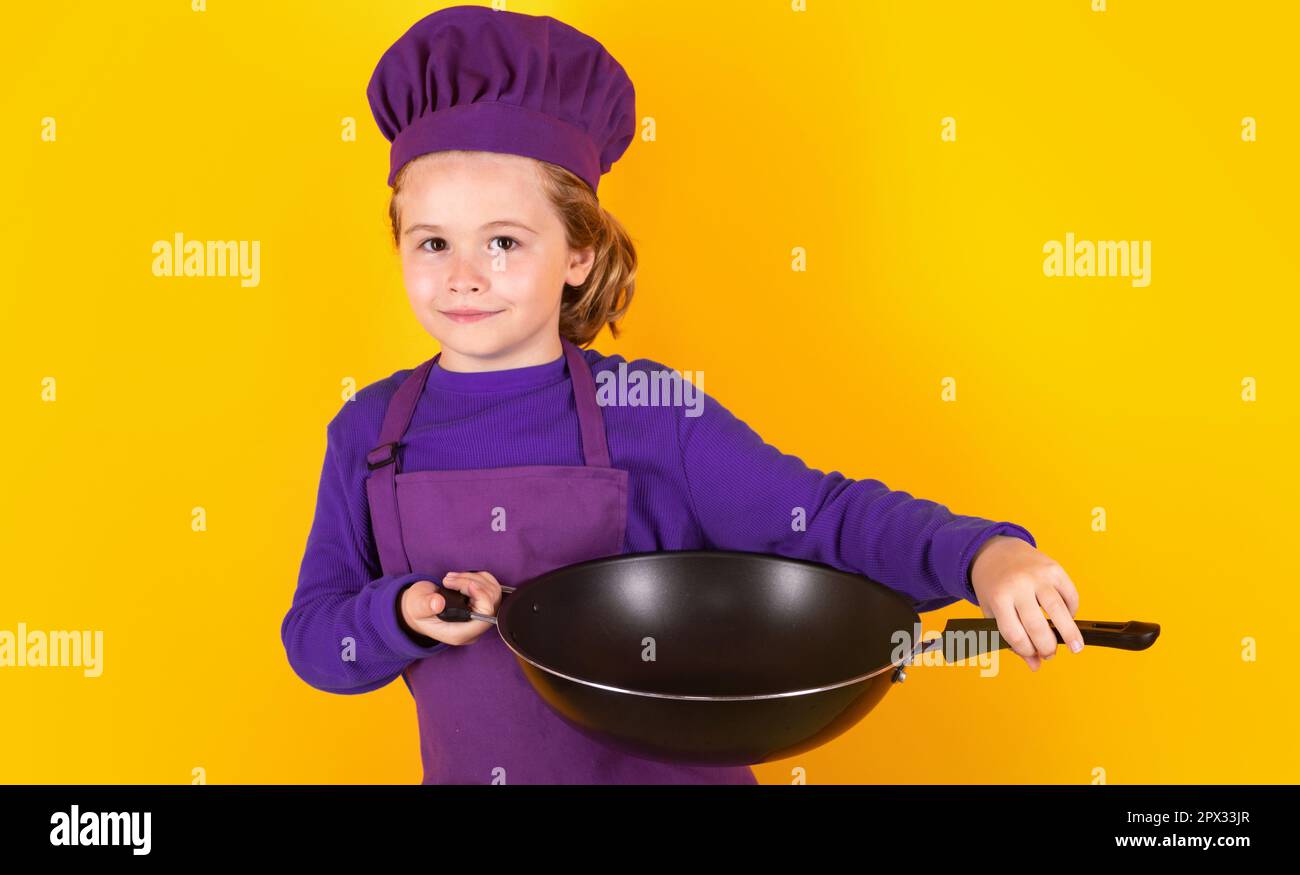 Kid cook with cooking pan. Portrait of little child in uniform of cook ...
