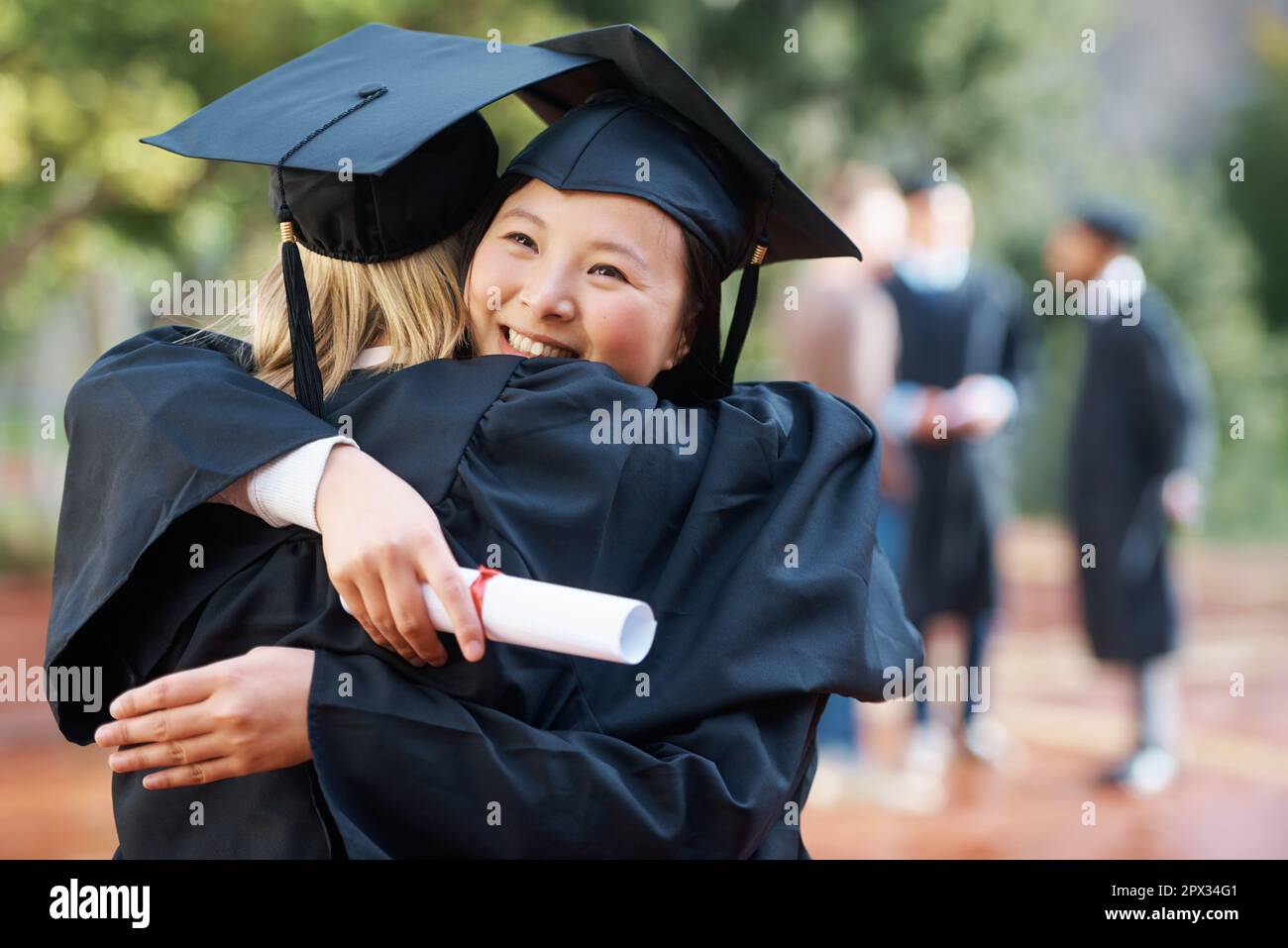 Weve finally graduated. Two college graduates hugging one another in ...