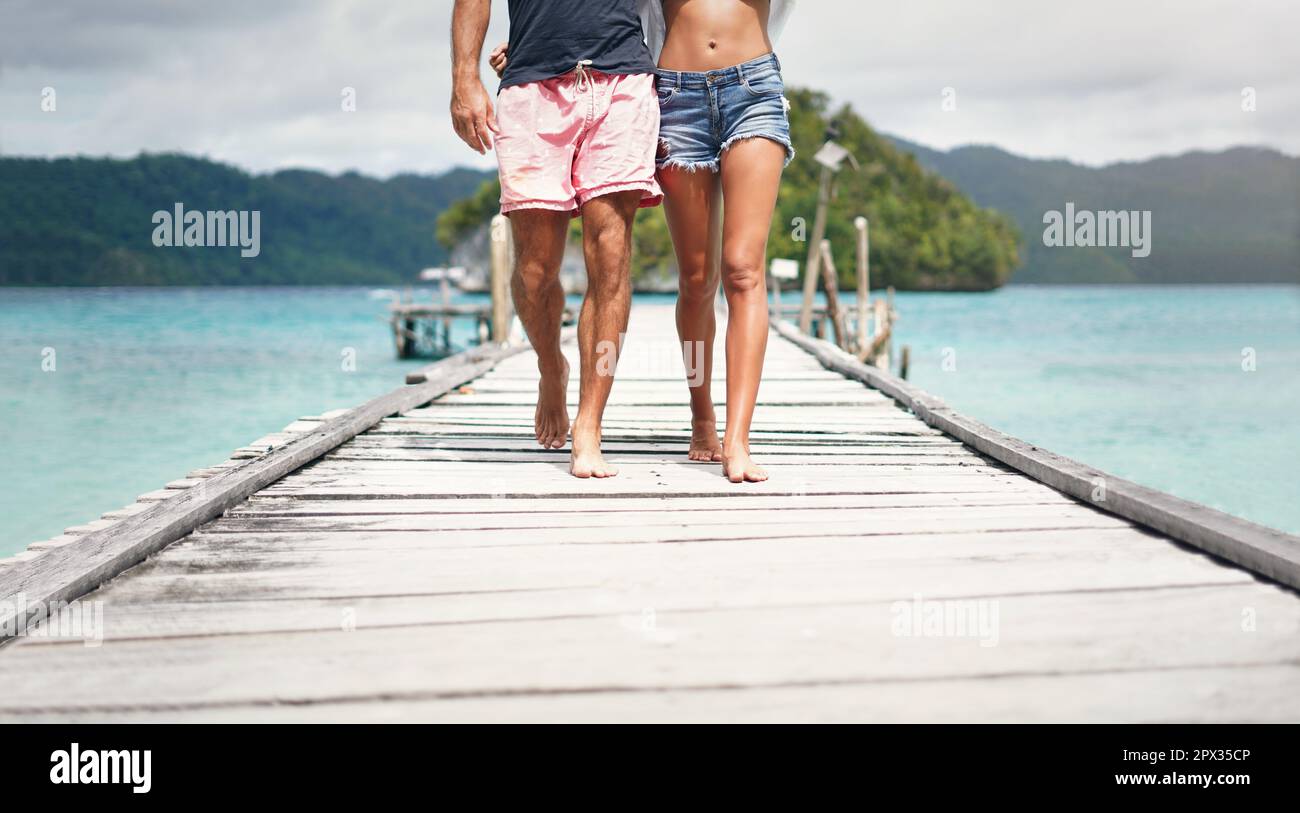 Spending some quality time with my love. an unrecognizable couple walking down a boardwalk ...