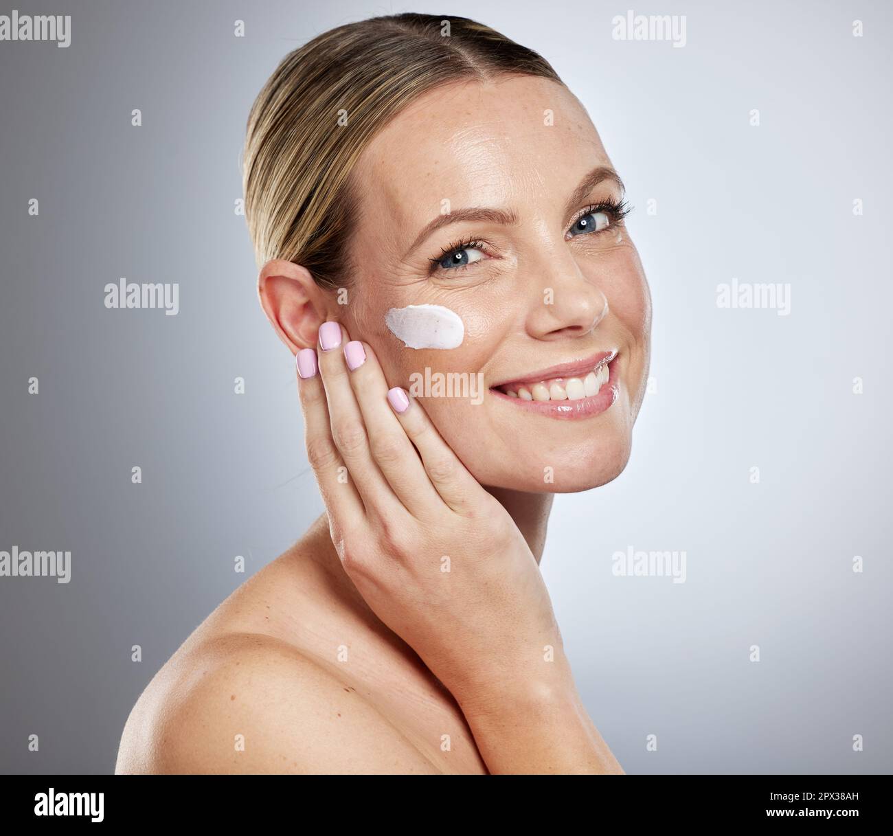 Woman, skincare and cream for face on studio background with sunscreen ...