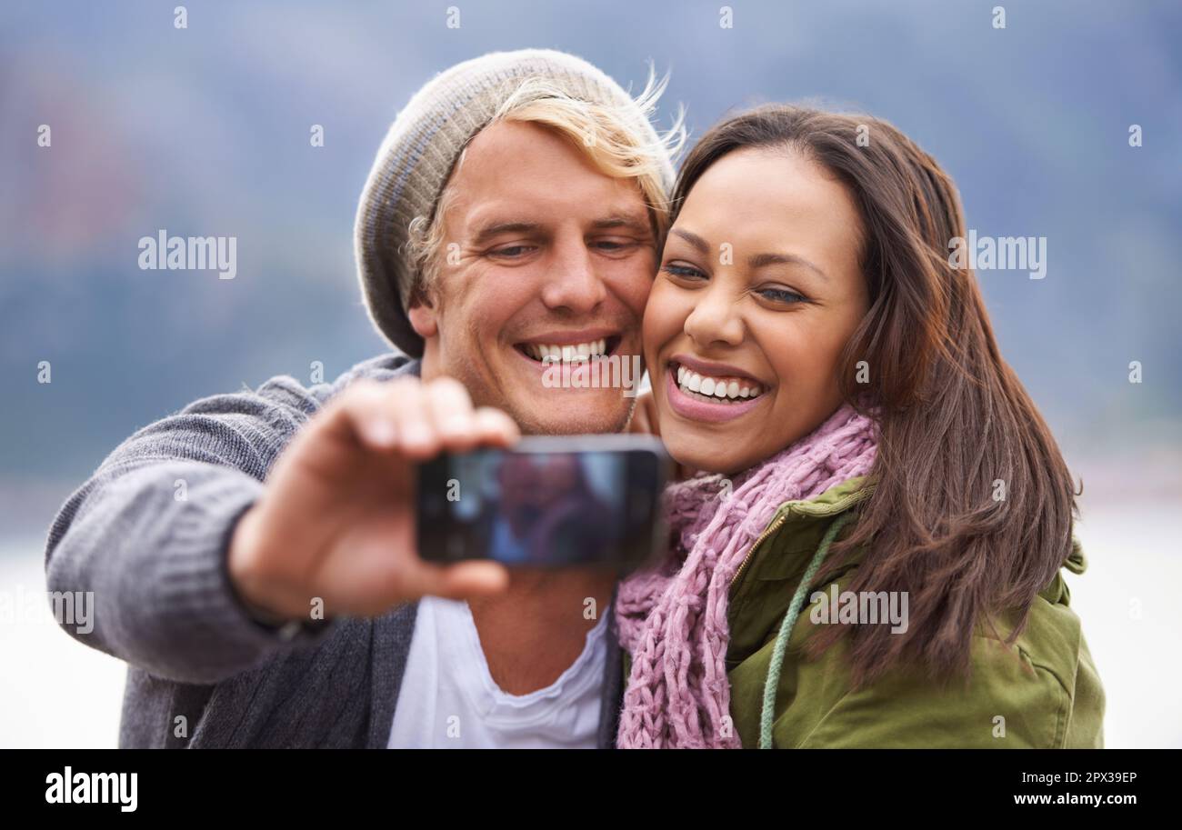 One fine looking couple. a young couple taking a self-portrait while ...