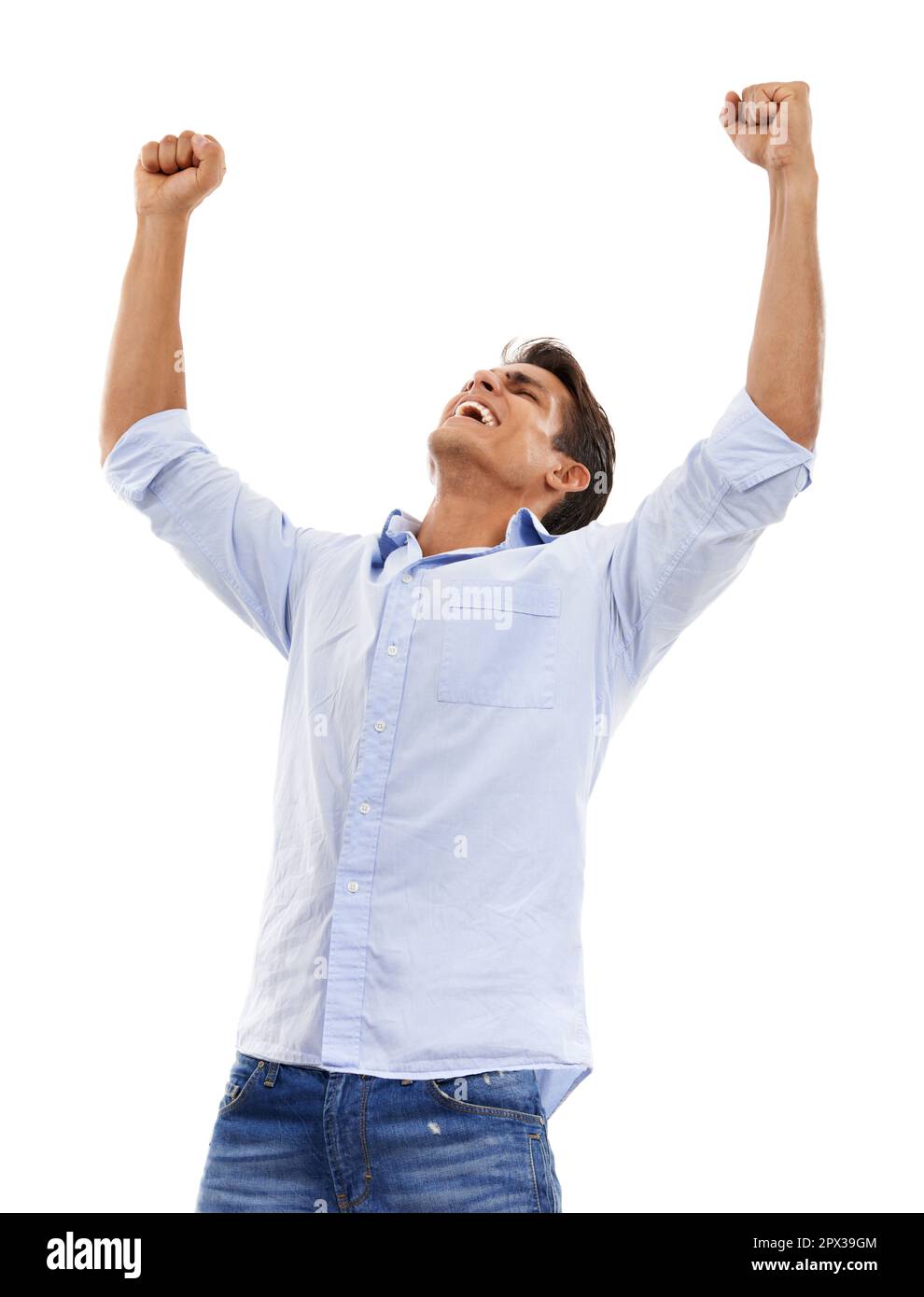 Feeling victorious. A handsome young man standing with his arms raised ...