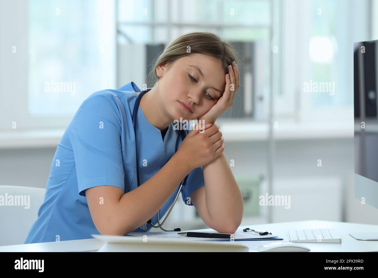 Exhausted doctor sleeping at workplace in hospital Stock Photo - Alamy