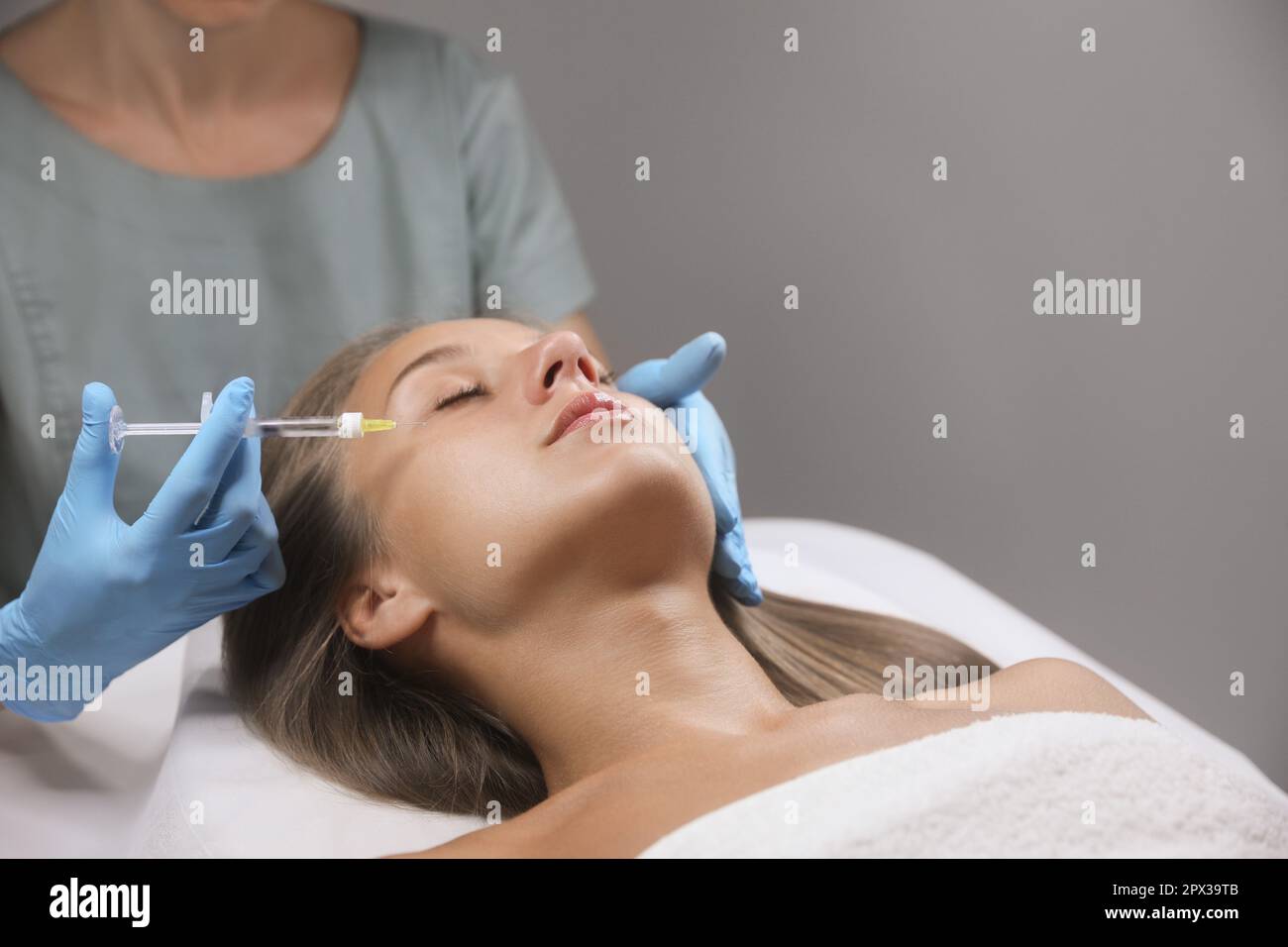 Beautiful woman getting facial injection in salon Stock Photo - Alamy