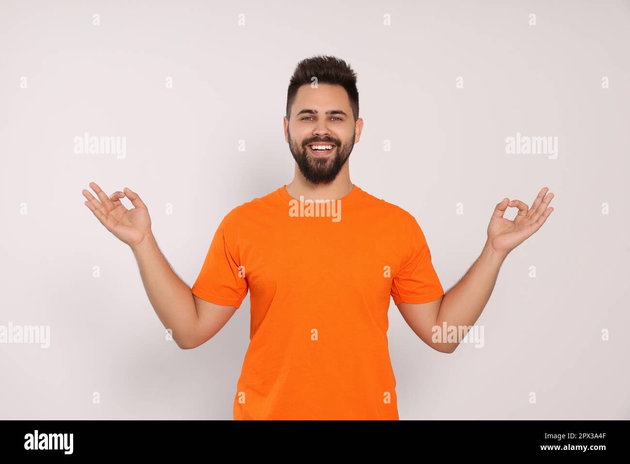 Young man meditating on white background. Zen concept Stock Photo - Alamy