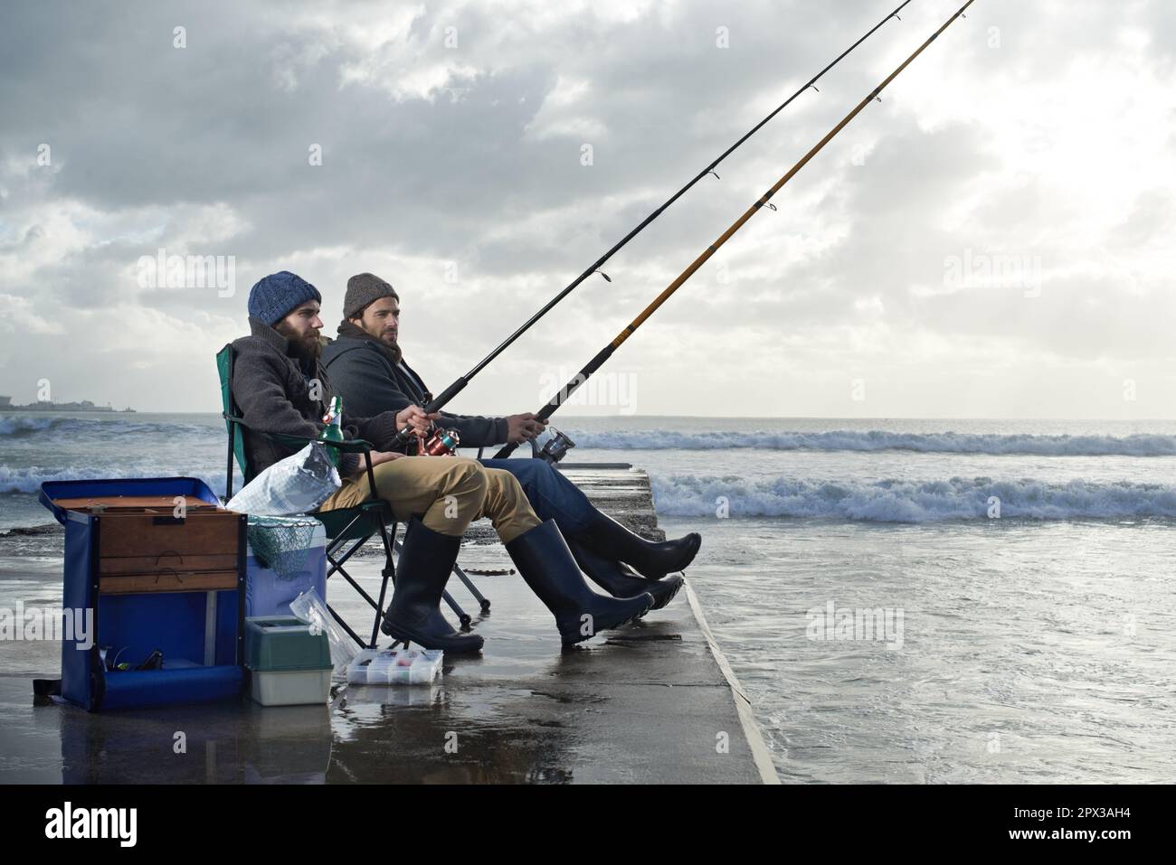 Just waiting for a bite. Full length shot of two young men fishing at ...