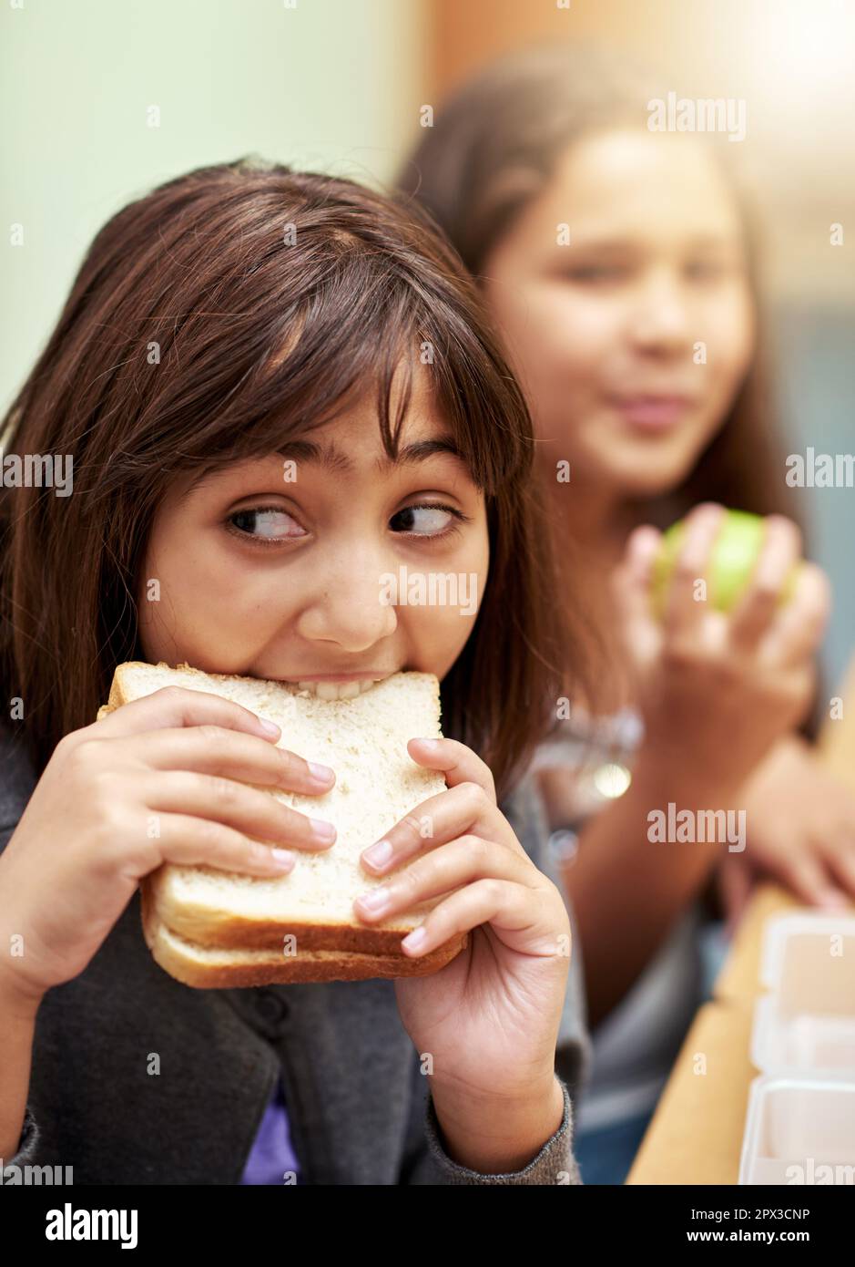 Eating quickly to beat the bell. young school children eating lunch at ... Eating quickly to beat the bell. young school children eating lunch at ...