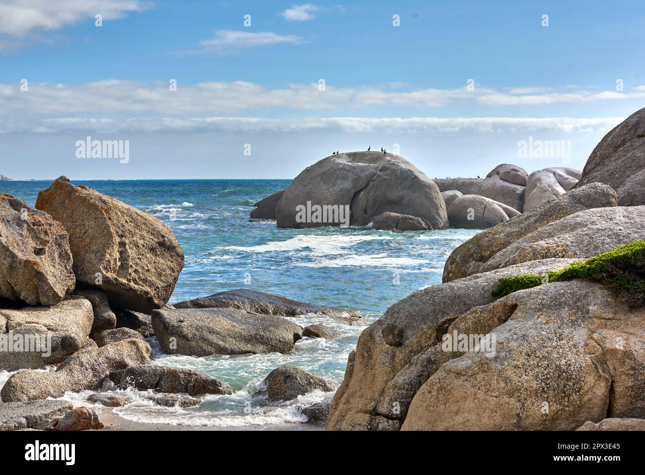Beautiful sea view of big boulders and ocean water on a sunny beach day ...