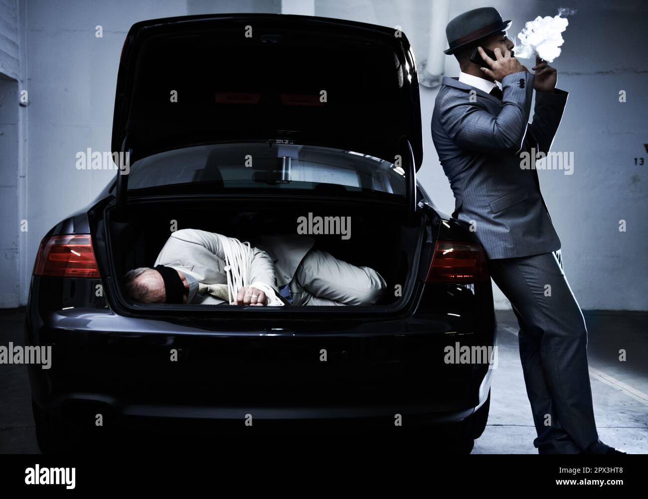 Ready and waiting. An arrogant mobster blowing cigar smoke into the air ...