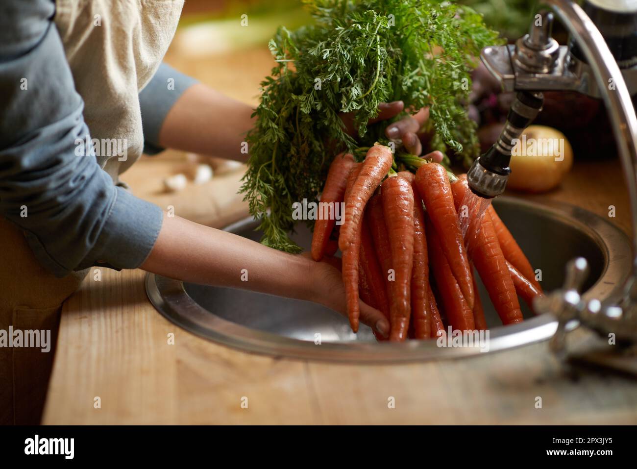 Washing them off before its time to cook. High angle shot of a woman ...