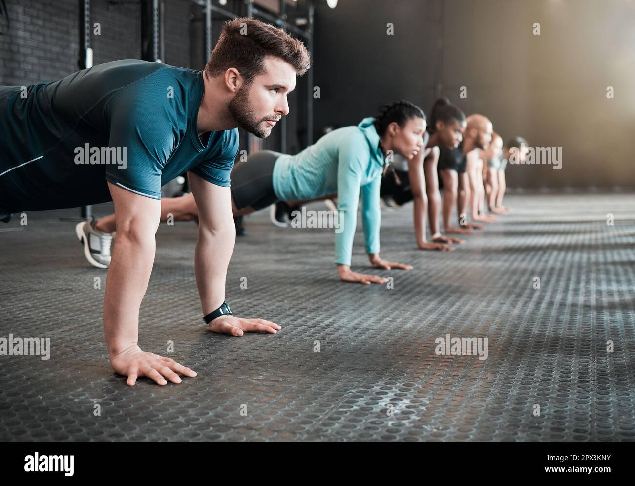 Push through you can do it. a group of friends planking together Stock ...