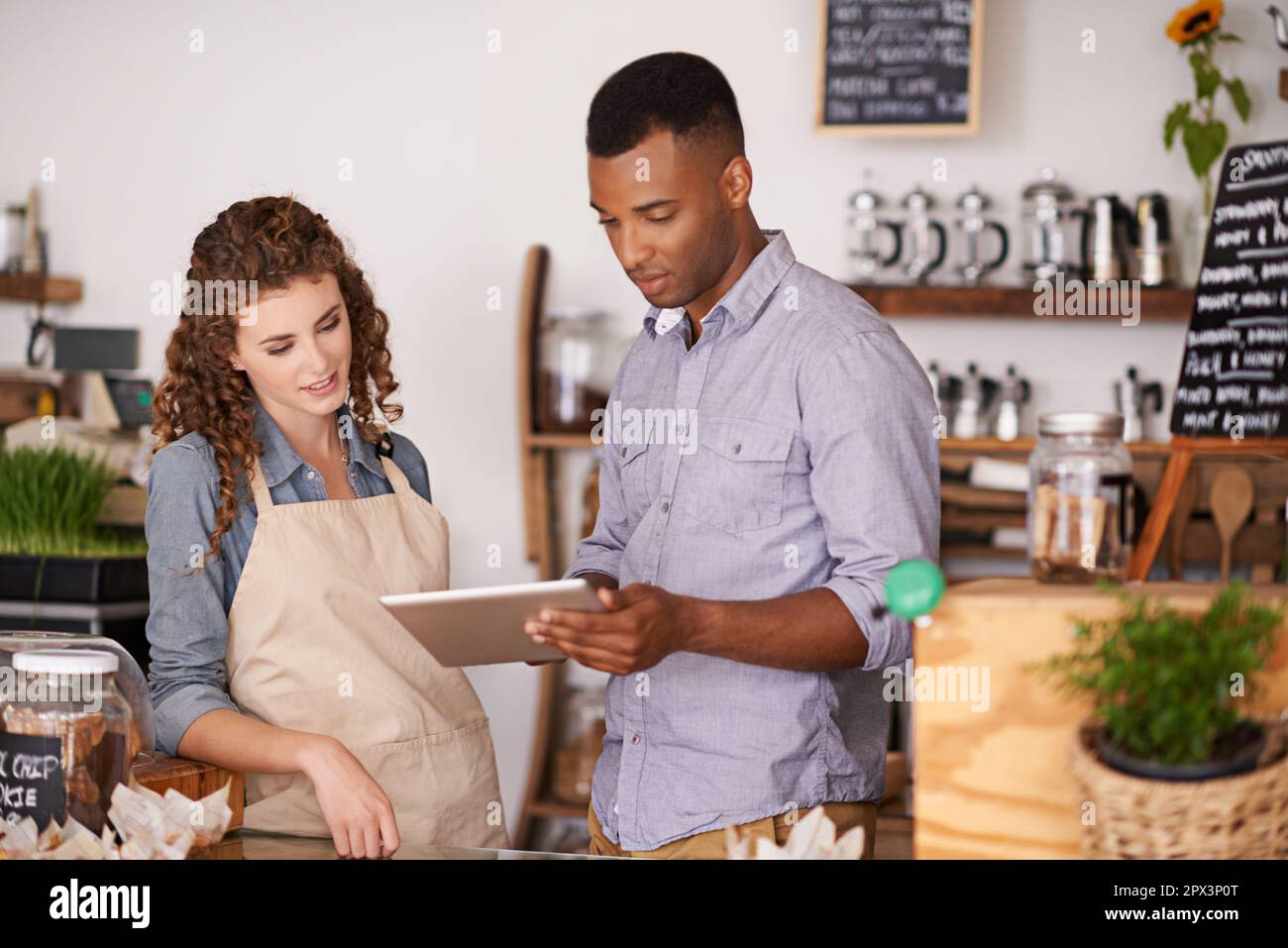 Tablet, cafe barista and teamwork of people, discussion and training in ...