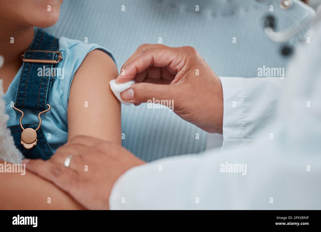 Prepping the spot before her shot. Closeup shot of a doctor using a ...