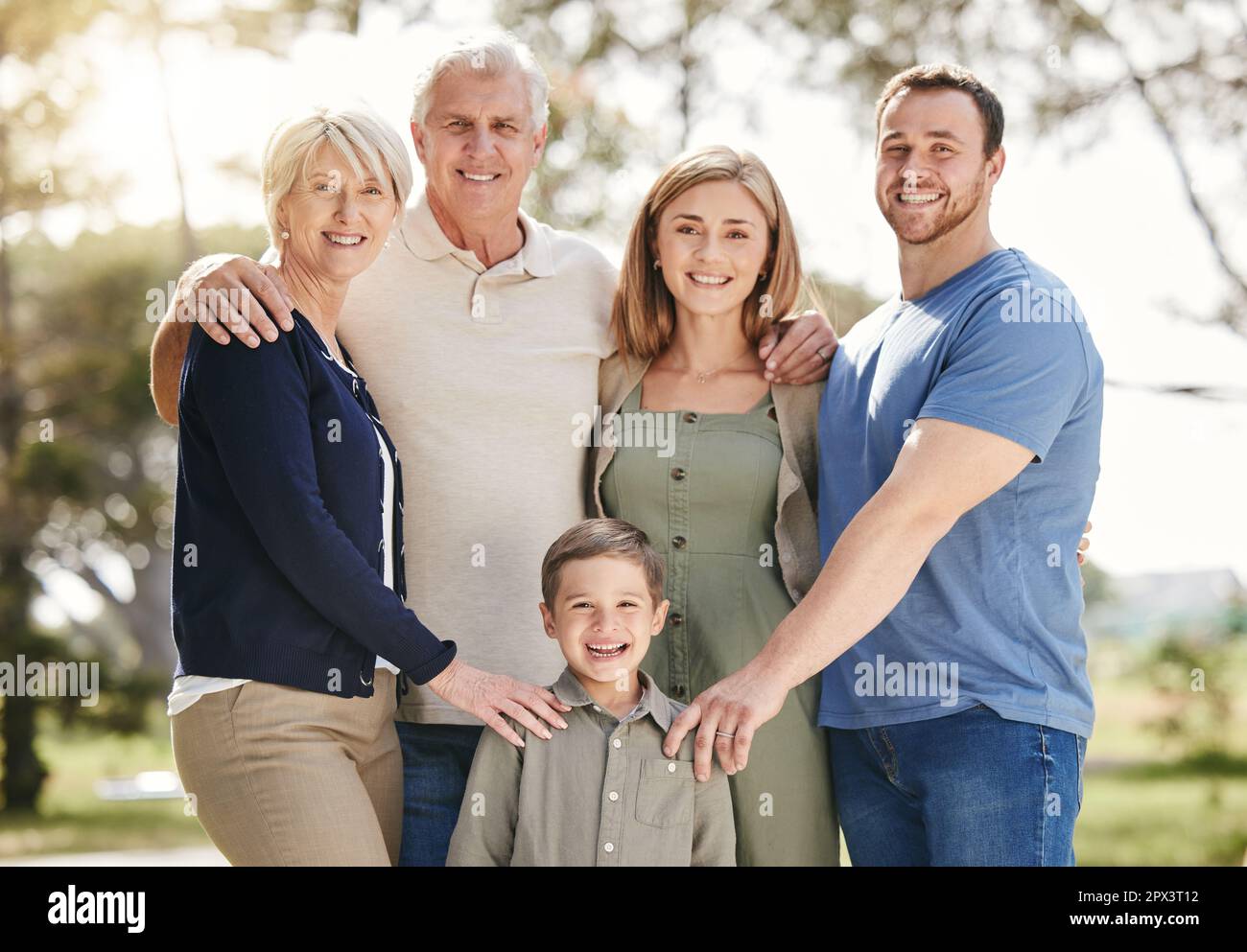Portrait of a smiling multi generation caucasian family standing close ...