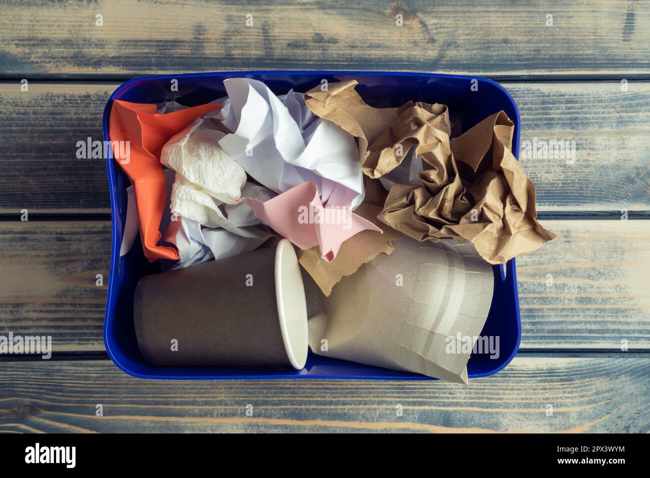 Blue plastic container box full of crumpled paper waste, rubbish on ...