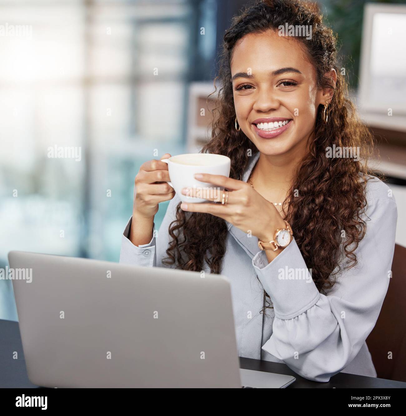 I feel ready to tackle the day. a young businesswoman enjoying a cup of coffee at work Stock ...