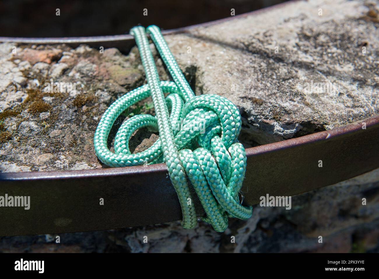 A green rope knotted on a rusty railing Stock Photo - Alamy