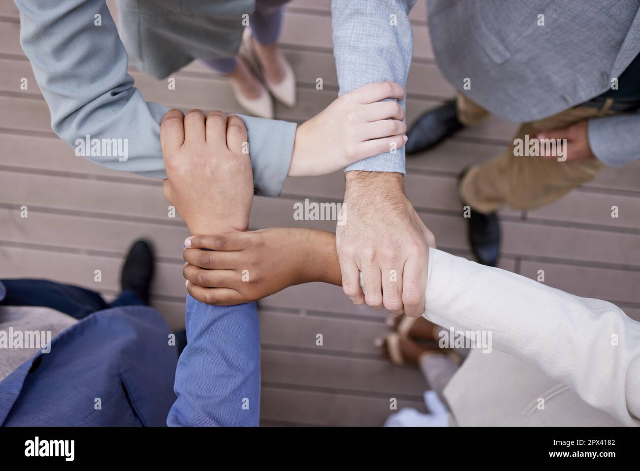 Diverse team linking arms hi-res stock photography and images - Alamy
