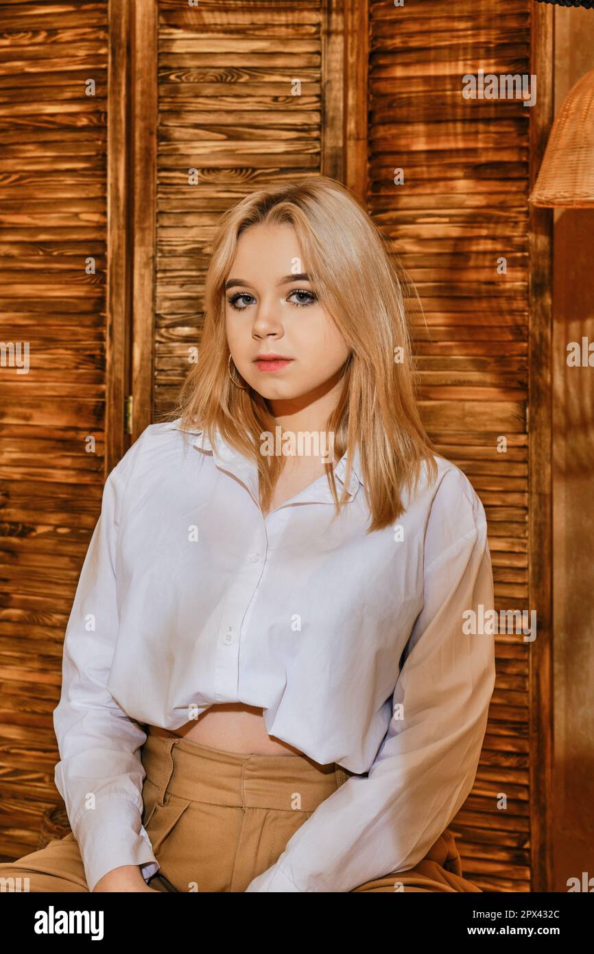 Teenager girl sit on a padded stool in relaxing environment Stock Photo ...