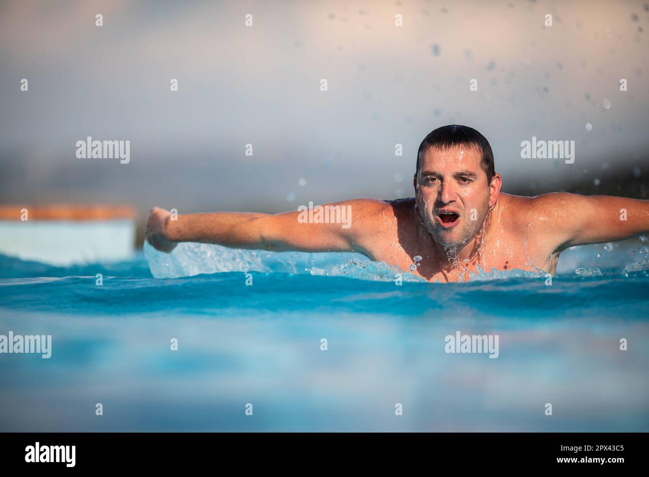 Male swimmer swimming in an outdoor pool - keeping fit Stock Photo - Alamy