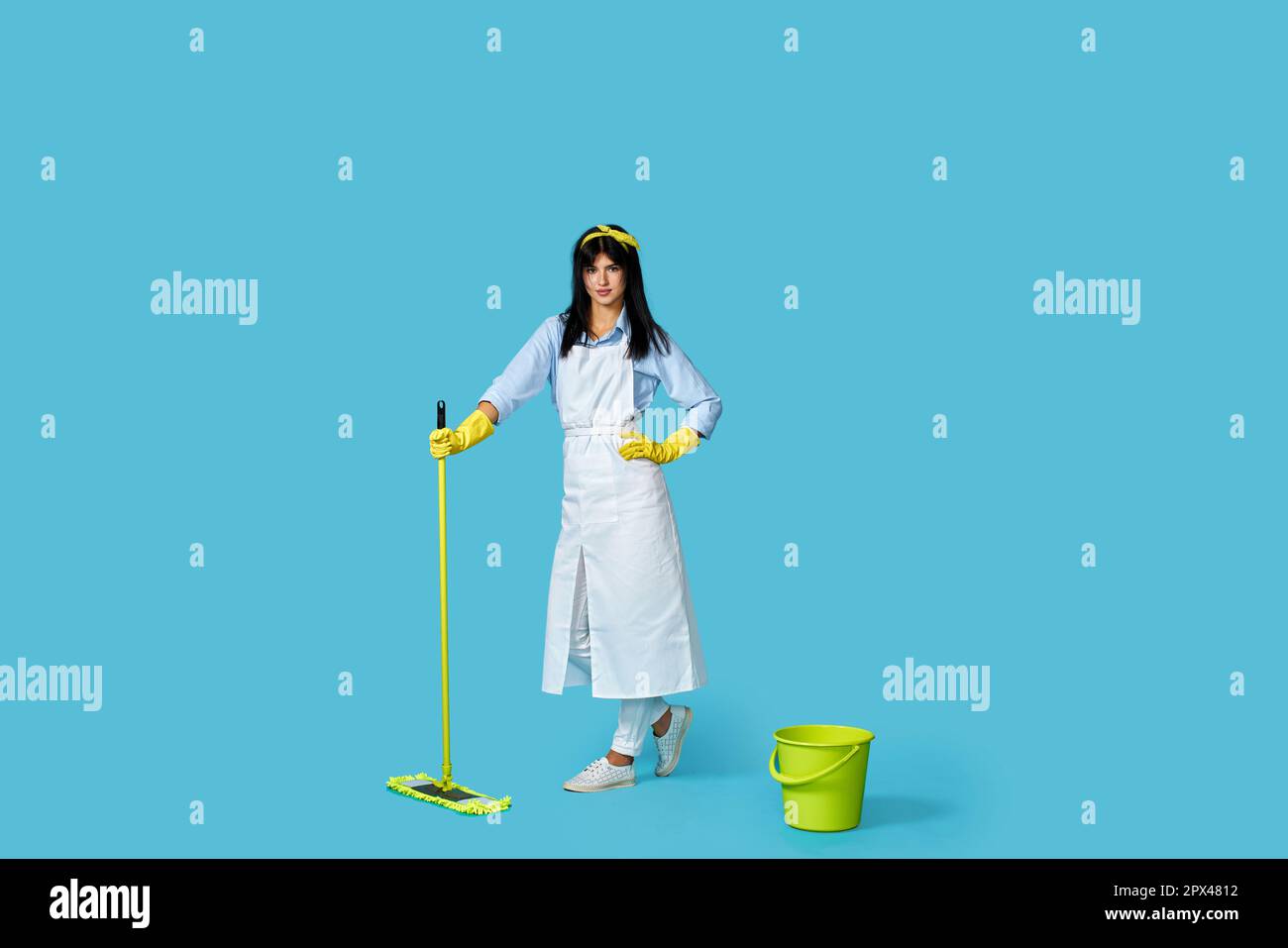 professional cleaner girl in rubber gloves and cleaner apron washing ...