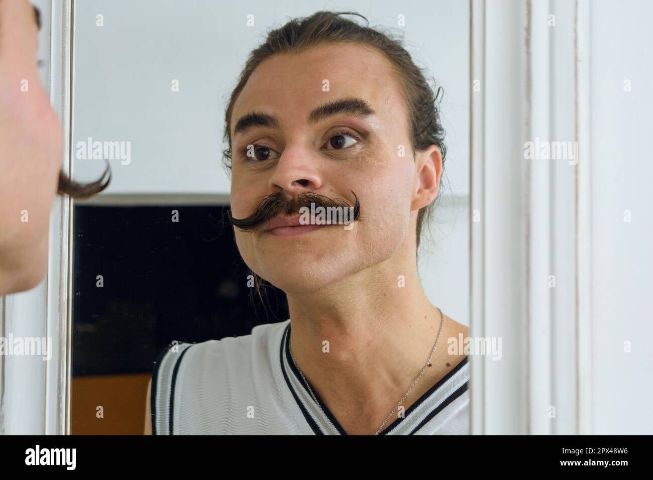 Reflection in the mirror of a young Latino person of Argentine ...