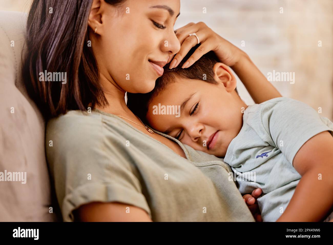 Cuddle, mother and child with smile on the sofa in the living room for ...