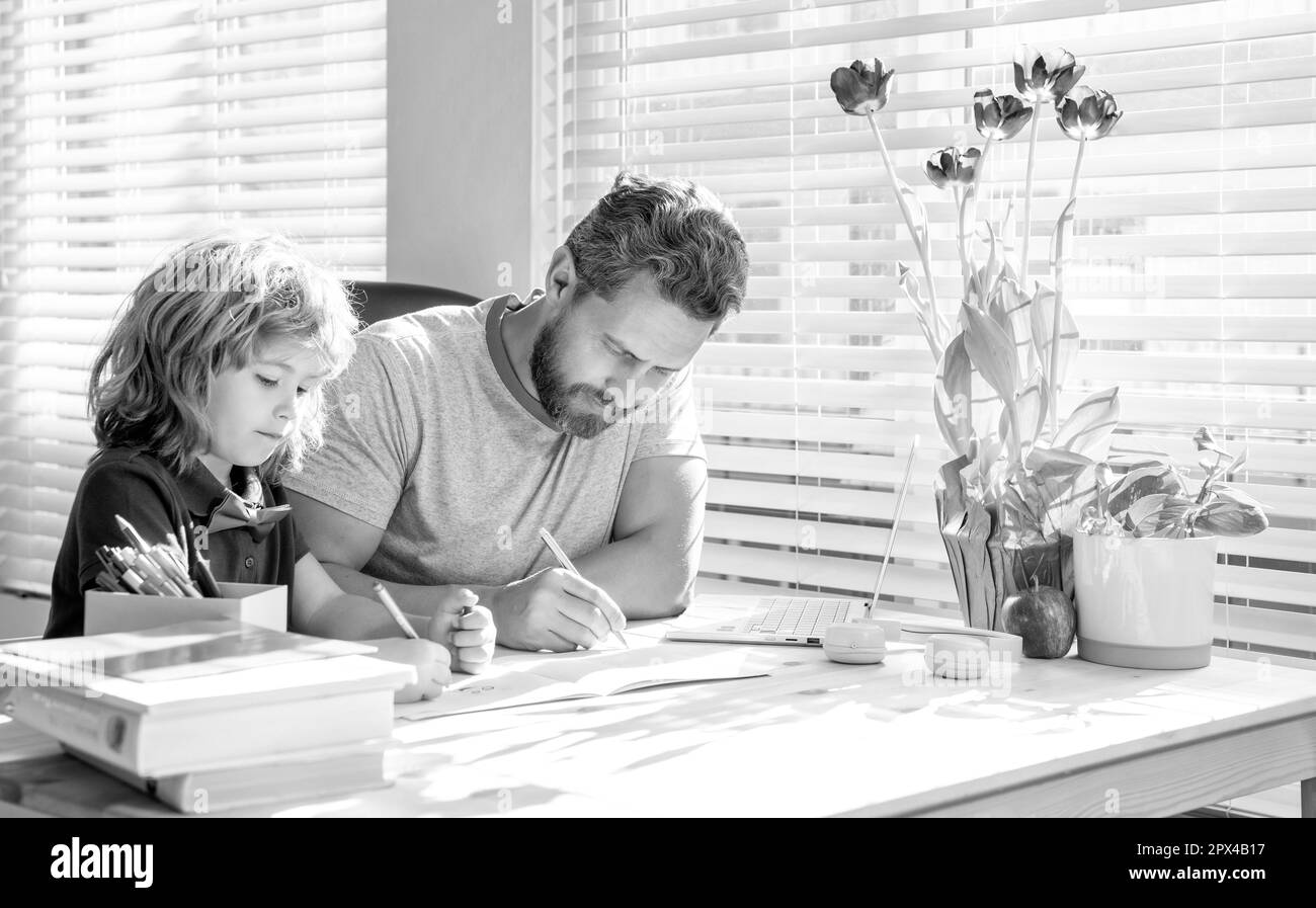 bearded father writing school homework with his child son in classroom ...
