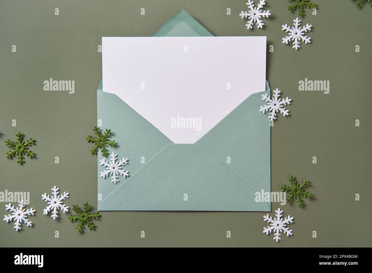 Christmas card flat lay. Empty card in green envelope. Holiday and ...