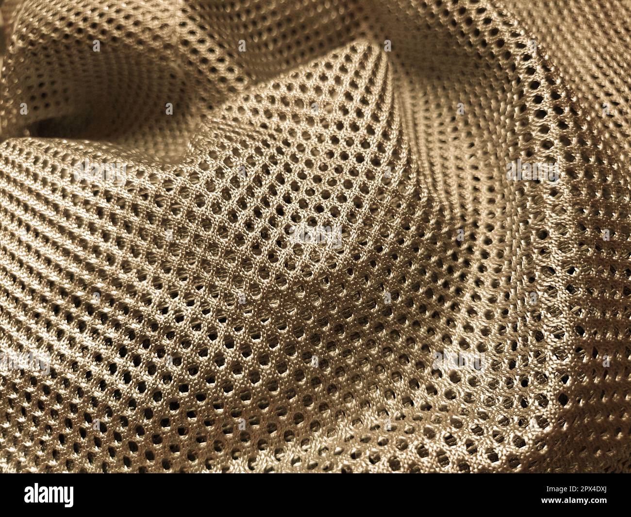 Synthetic polyester fabric with holes. Abstract background. A piece of ...