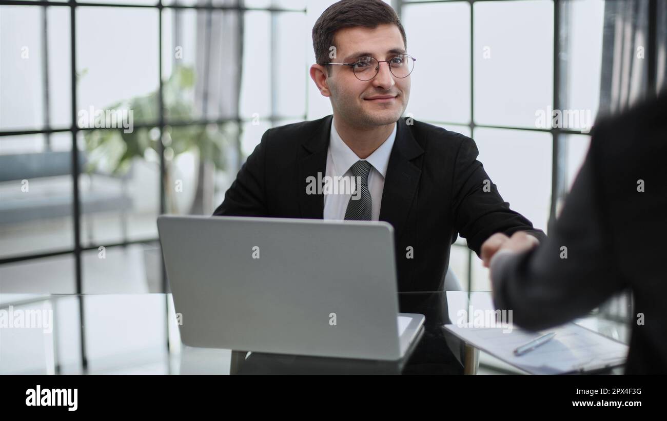 Portrait of cheerful young manager handshake with new employee Stock ...