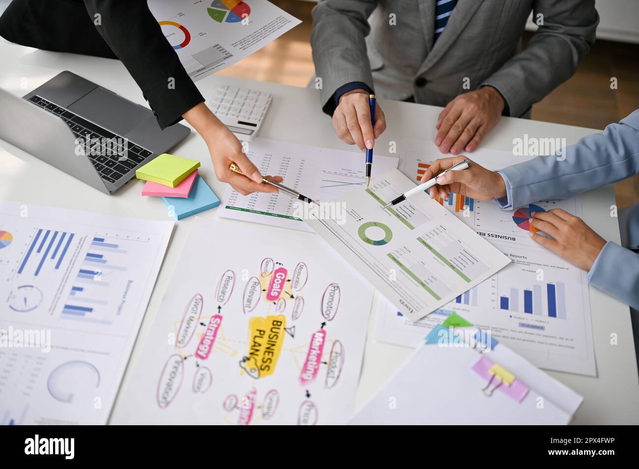 Top view of a professional businesspeople are pointing their pen at a ...