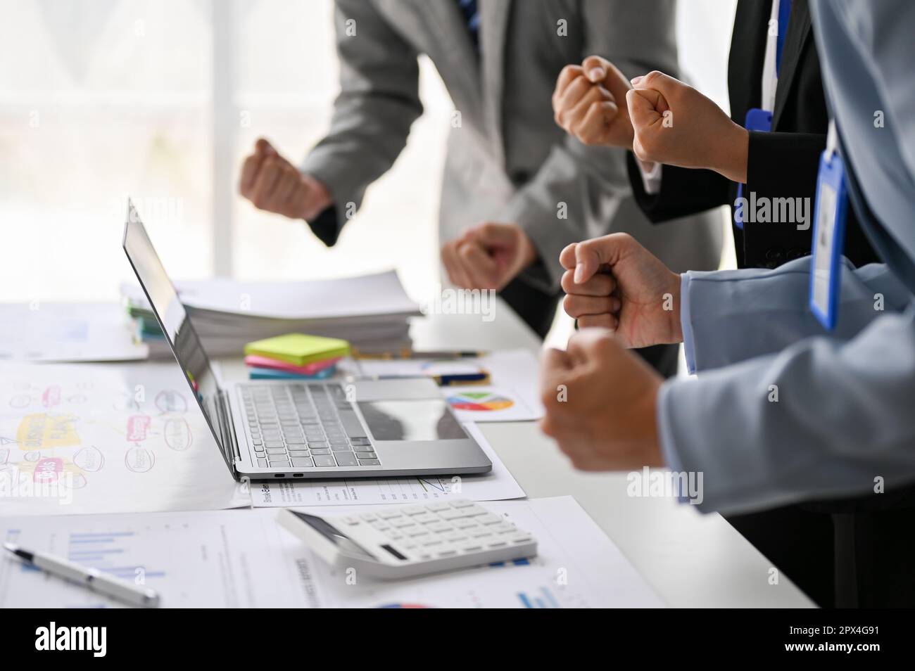 Close-up image of businesspeople clenching their fists in the meeting ...
