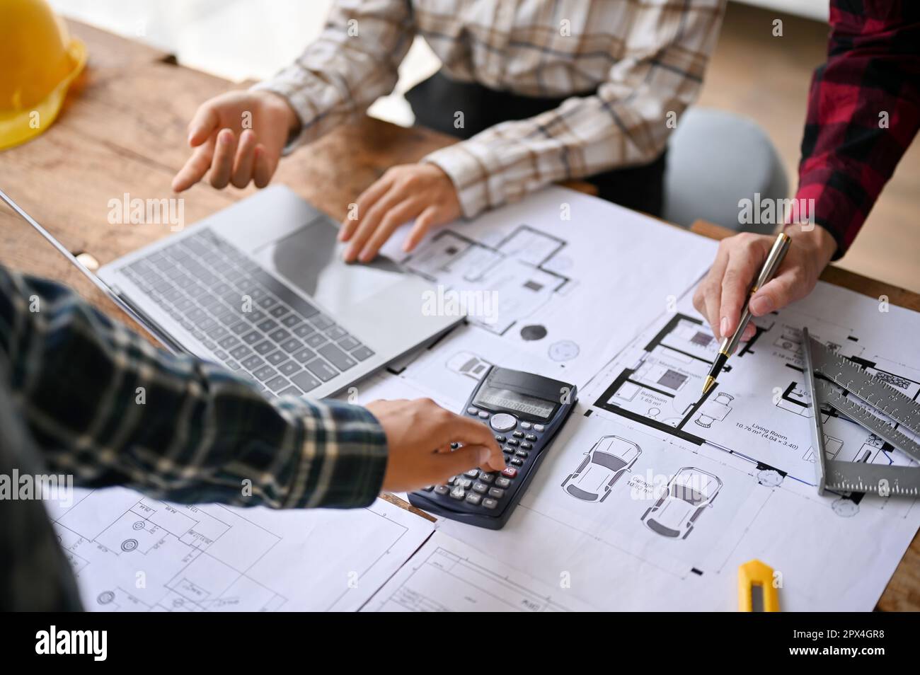 Close-up image of professional engineers are discussing, measuring and ...