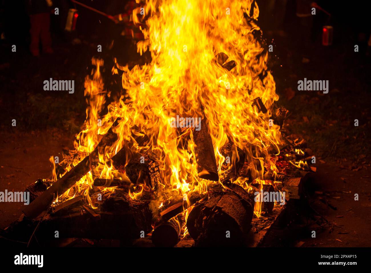 The orange glowing flames of a campfire at night Stock Photo - Alamy