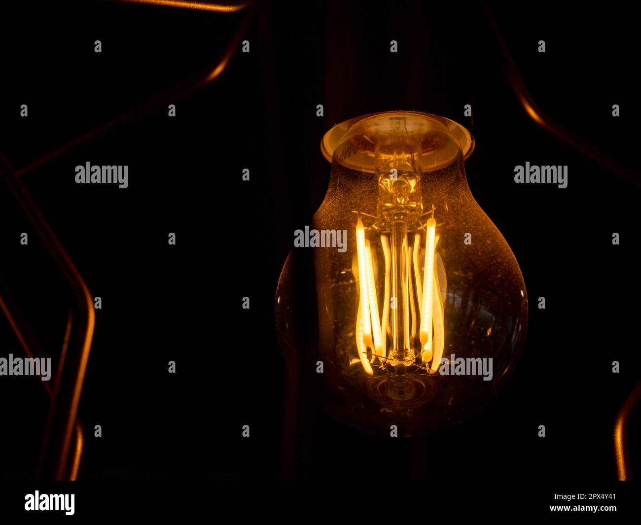 Vintage incandescent light bulb filament on black, close up shot Stock ...