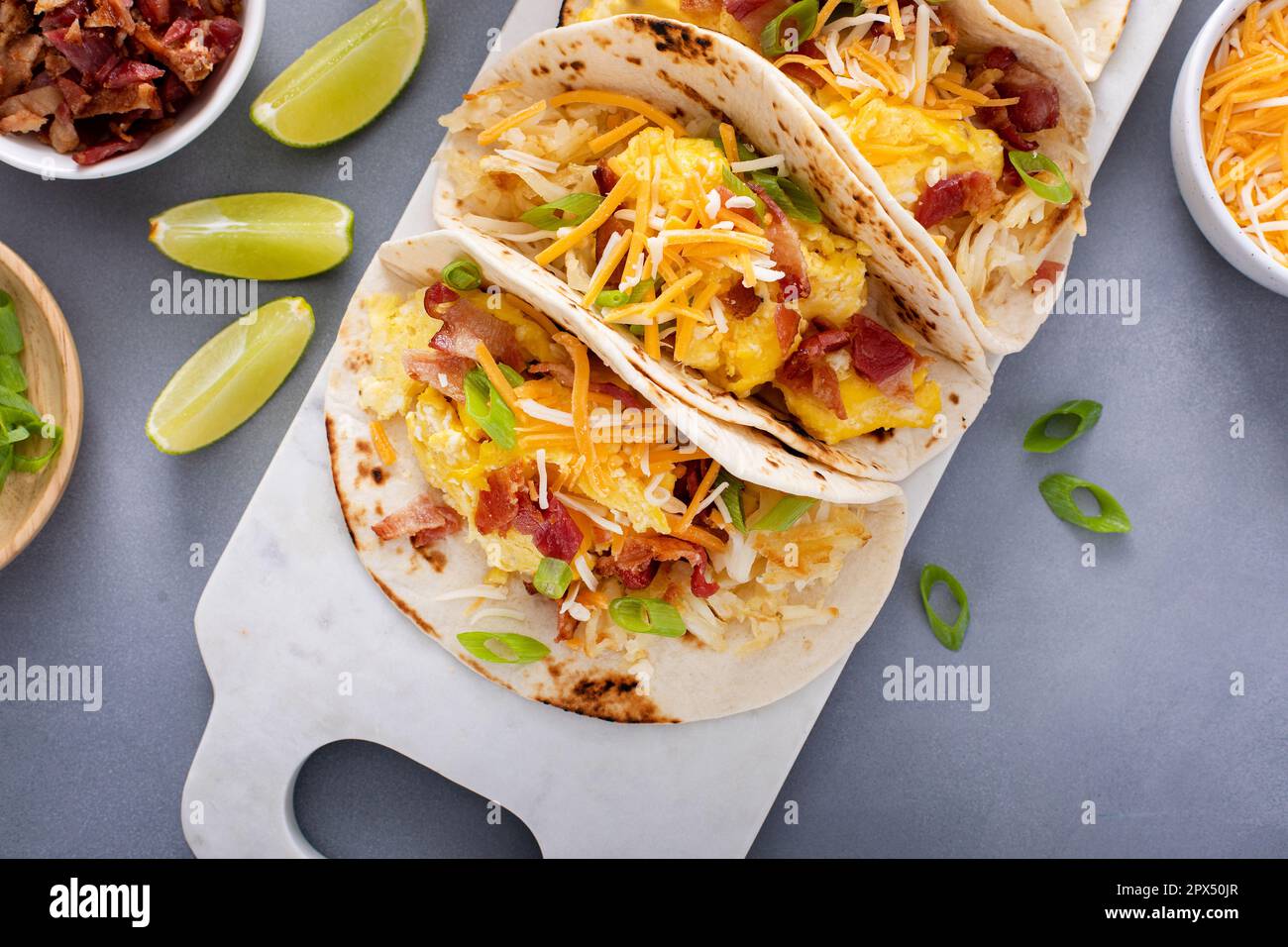 Breakfast tacos with hash browns, scrambled eggs, cheese and bacon ...