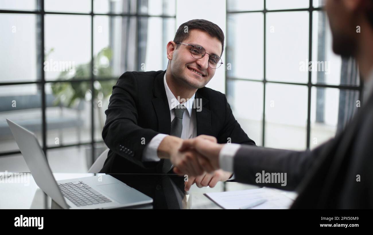 Nice to meet you in our team. Friendly man leader boss shake hand of ...